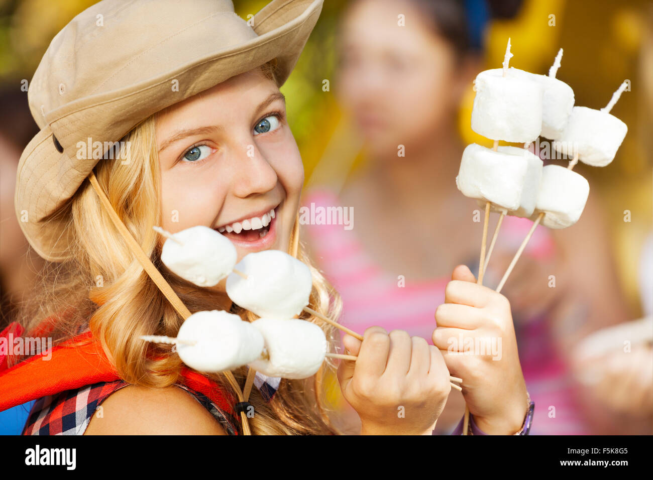 Portrait of girl holding sticks with marshmallow Stock Photo - Alamy