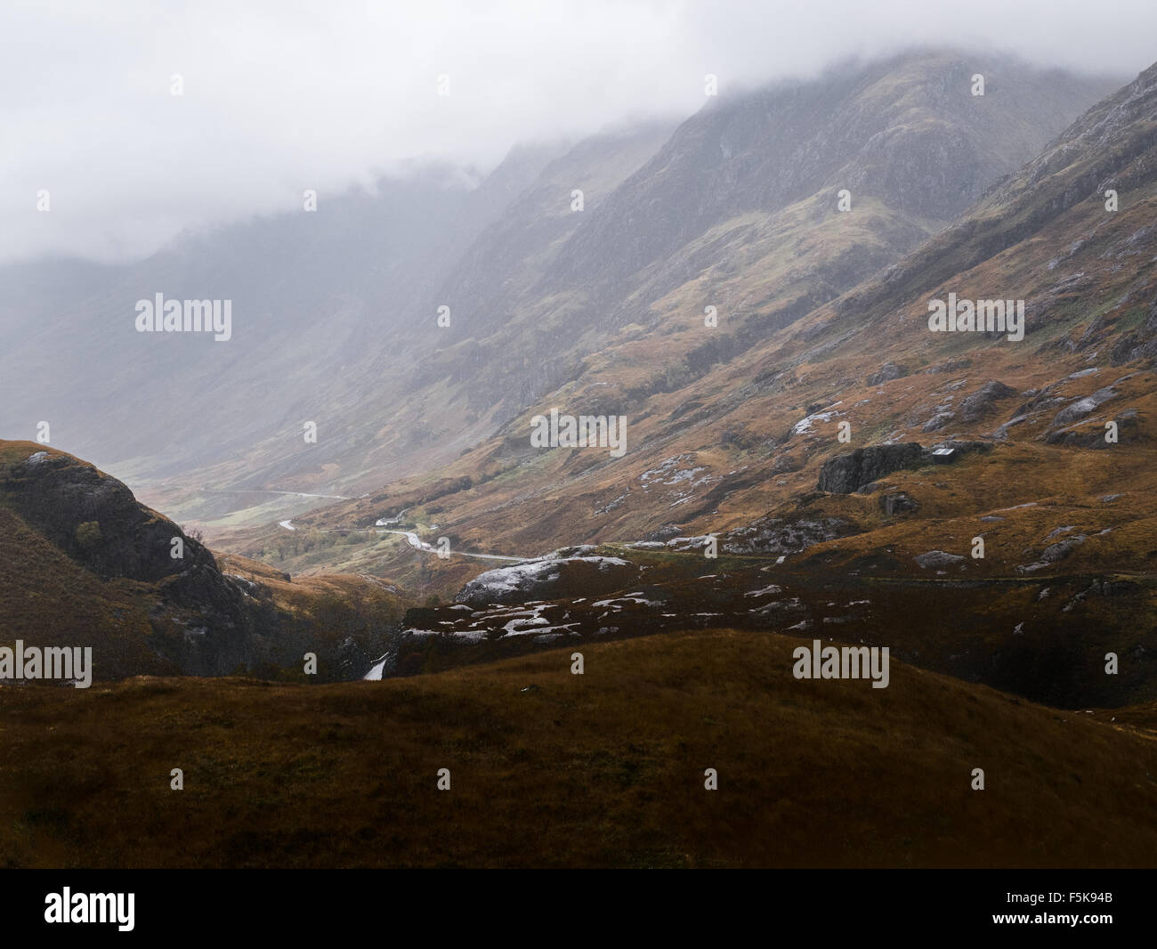 Mist and rain covering the mountains na dpass of Glencoe, scottish ...