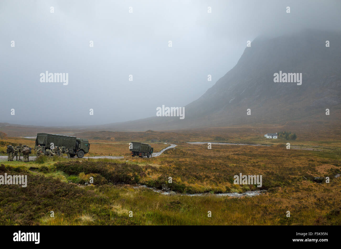 Soldiers get ready for a trek at the base of Stobe Derg, which is at ...