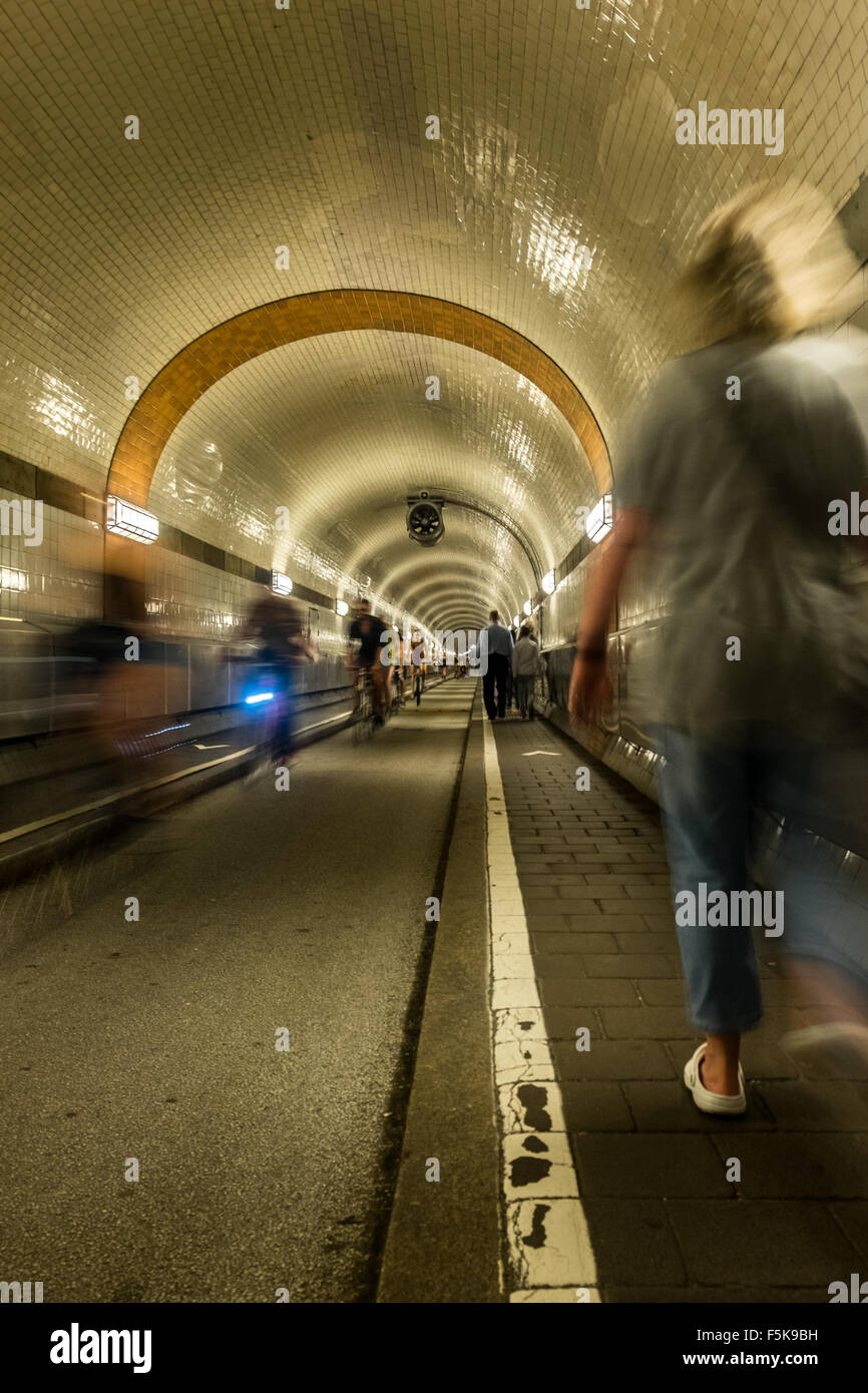 People moving through an underground tunnel Stock Photo - Alamy