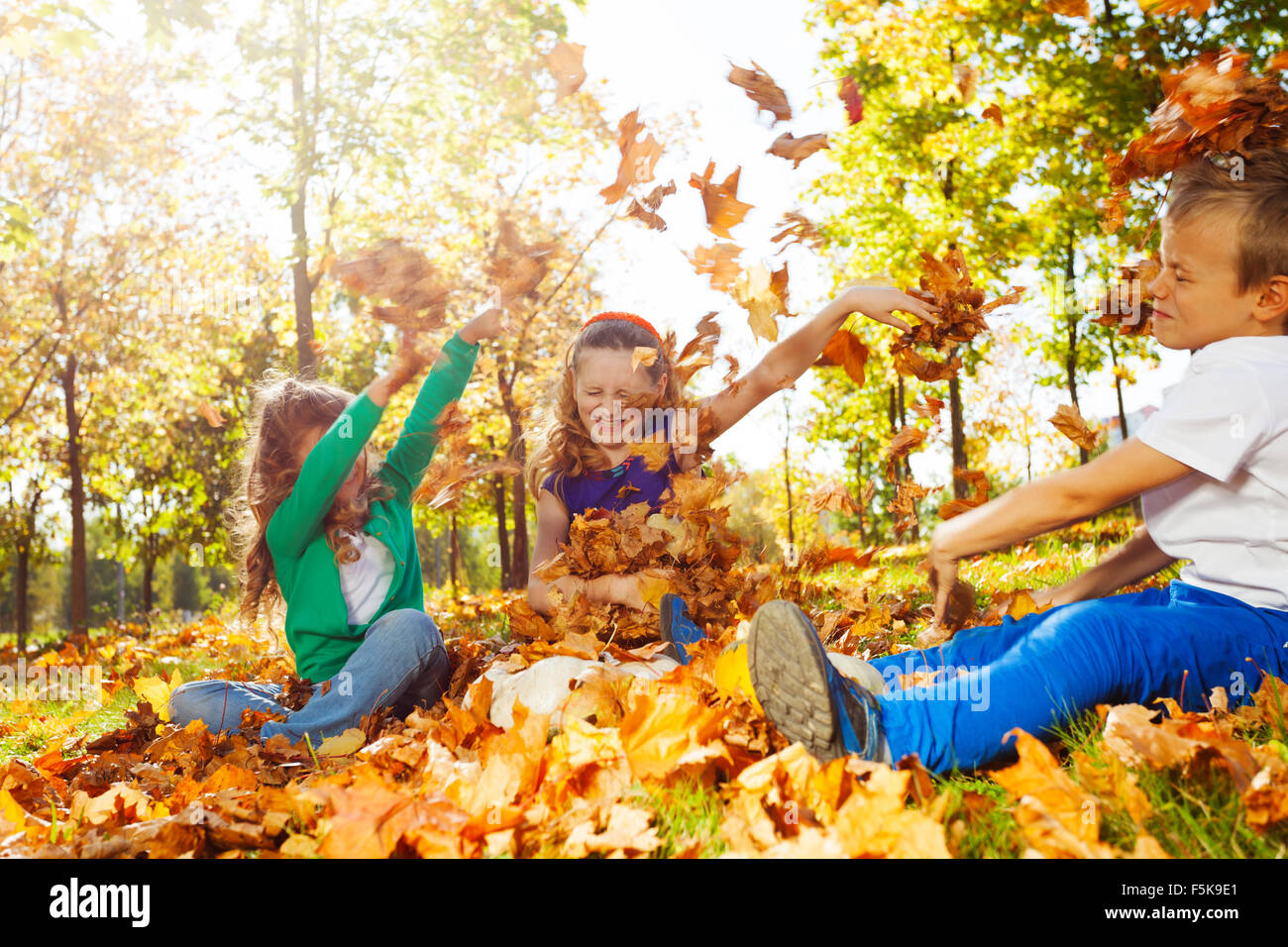 Play leaves happy childhood hi-res stock photography and images - Alamy