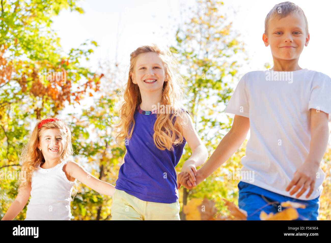 Kids playing outside hands up hi-res stock photography and images - Alamy