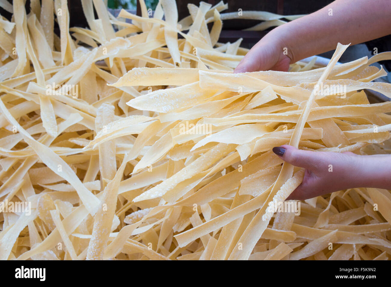 Homemade pasta in woman hands. Pasta production process Stock Photo - Alamy