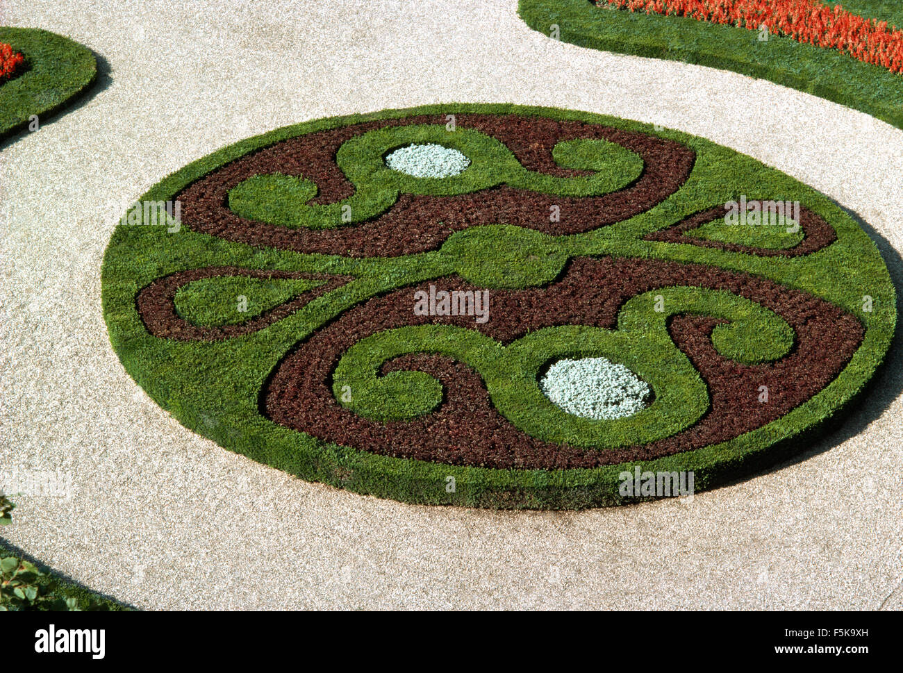 Formal knot garden with circular bed with annuals and closely mown ...