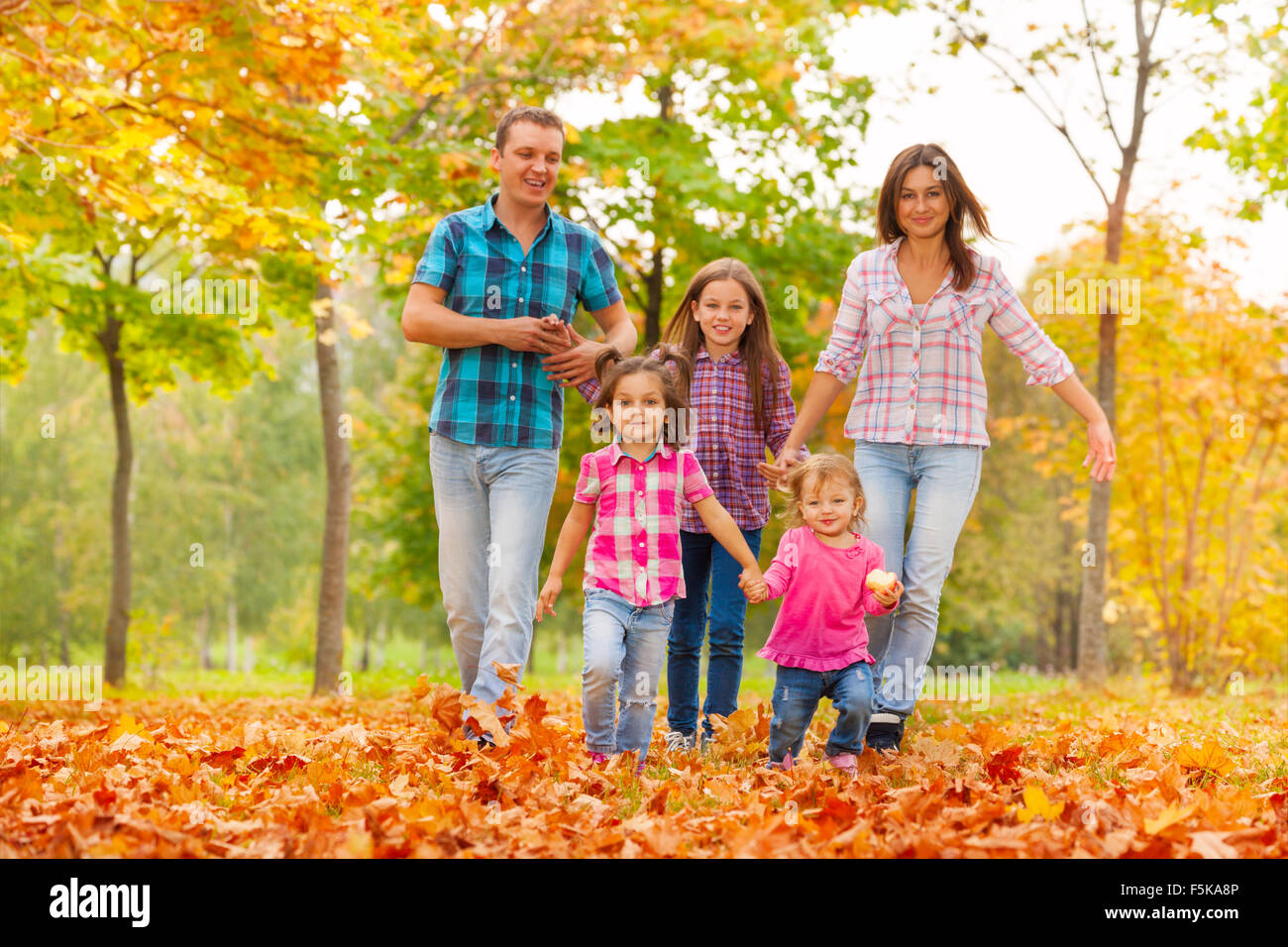 Happy cute family in the autumn October park Stock Photo - Alamy