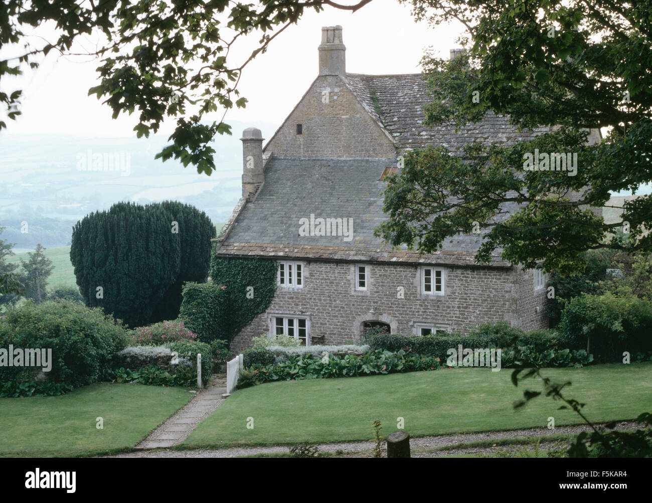 Exterior of a very old stone country house overlooking a Warwickshire ...