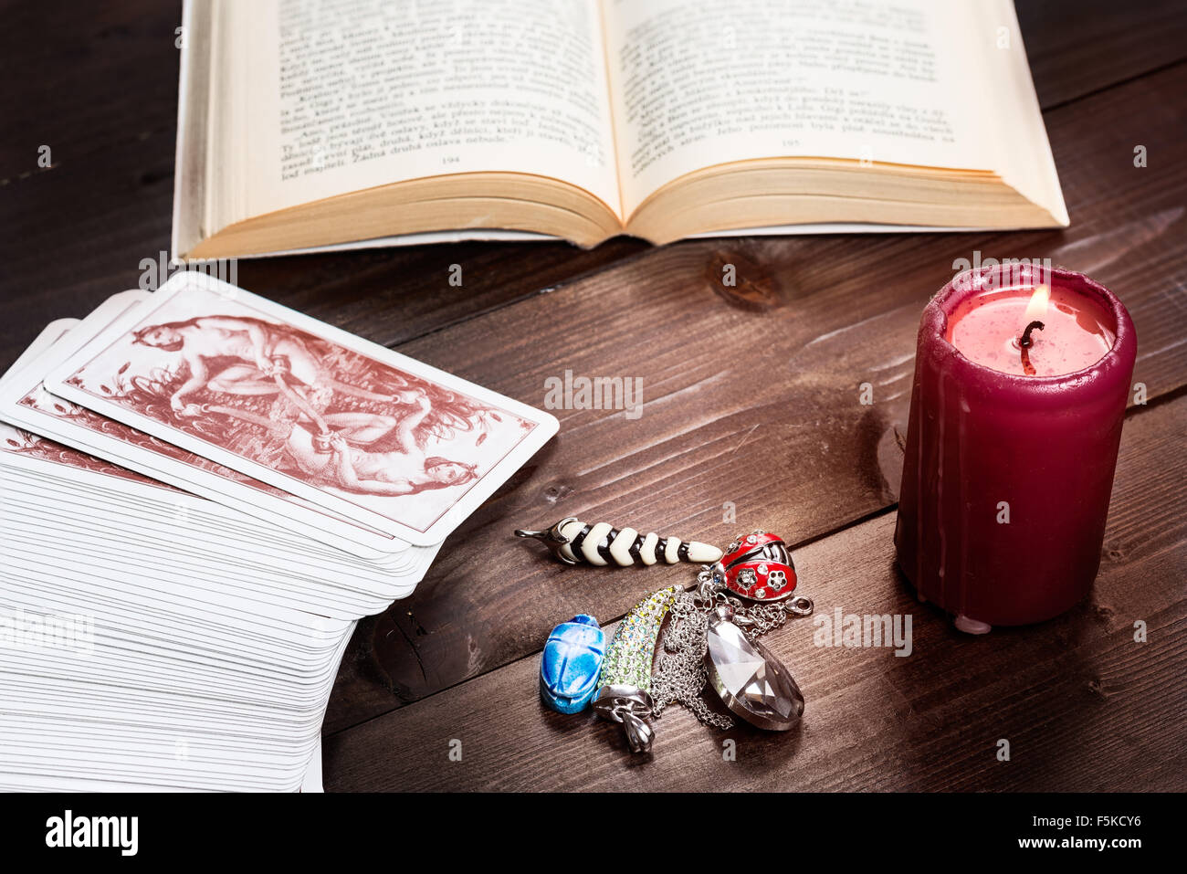 Composition of esoteric objects,candle,cards and book used for healing ...