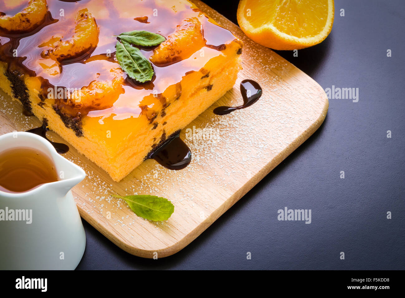 Orange cake with chocolate sauce for tea break Stock Photo - Alamy