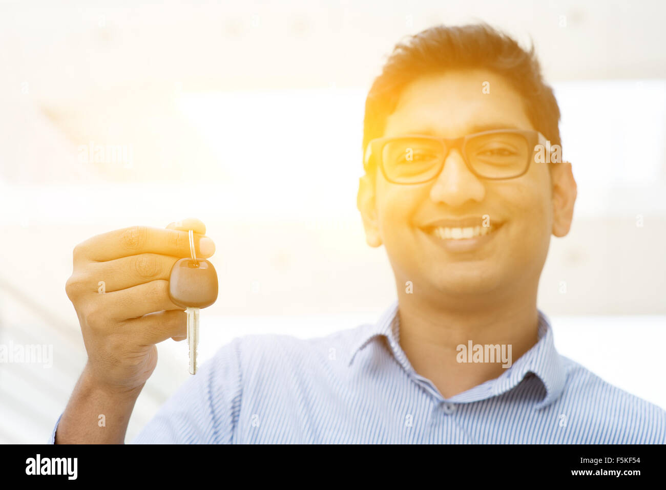 Young Asian Indian estate agent or salesman showing a key, India male ...