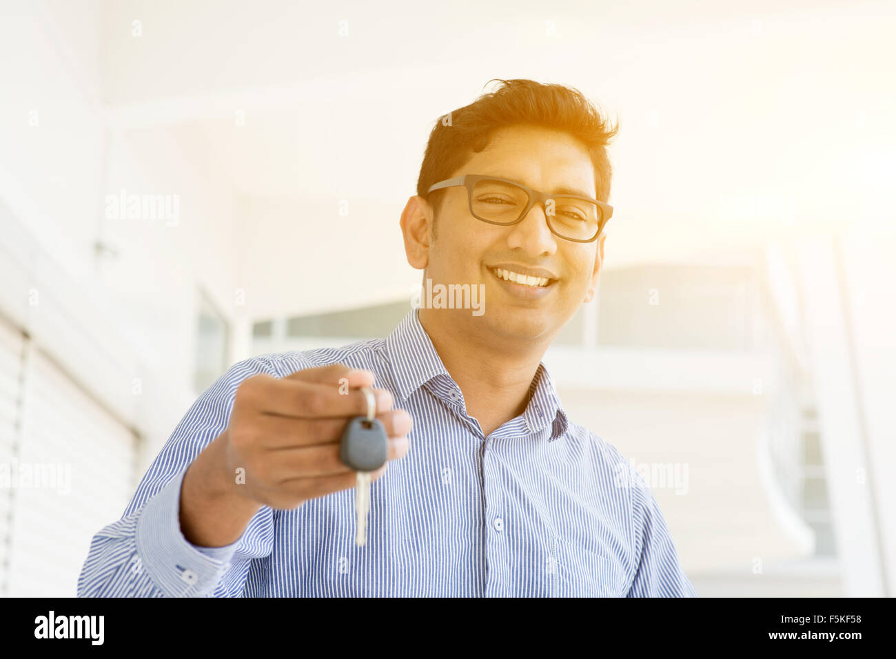 Asian Indian estate agent or salesman showing a key, India male ...