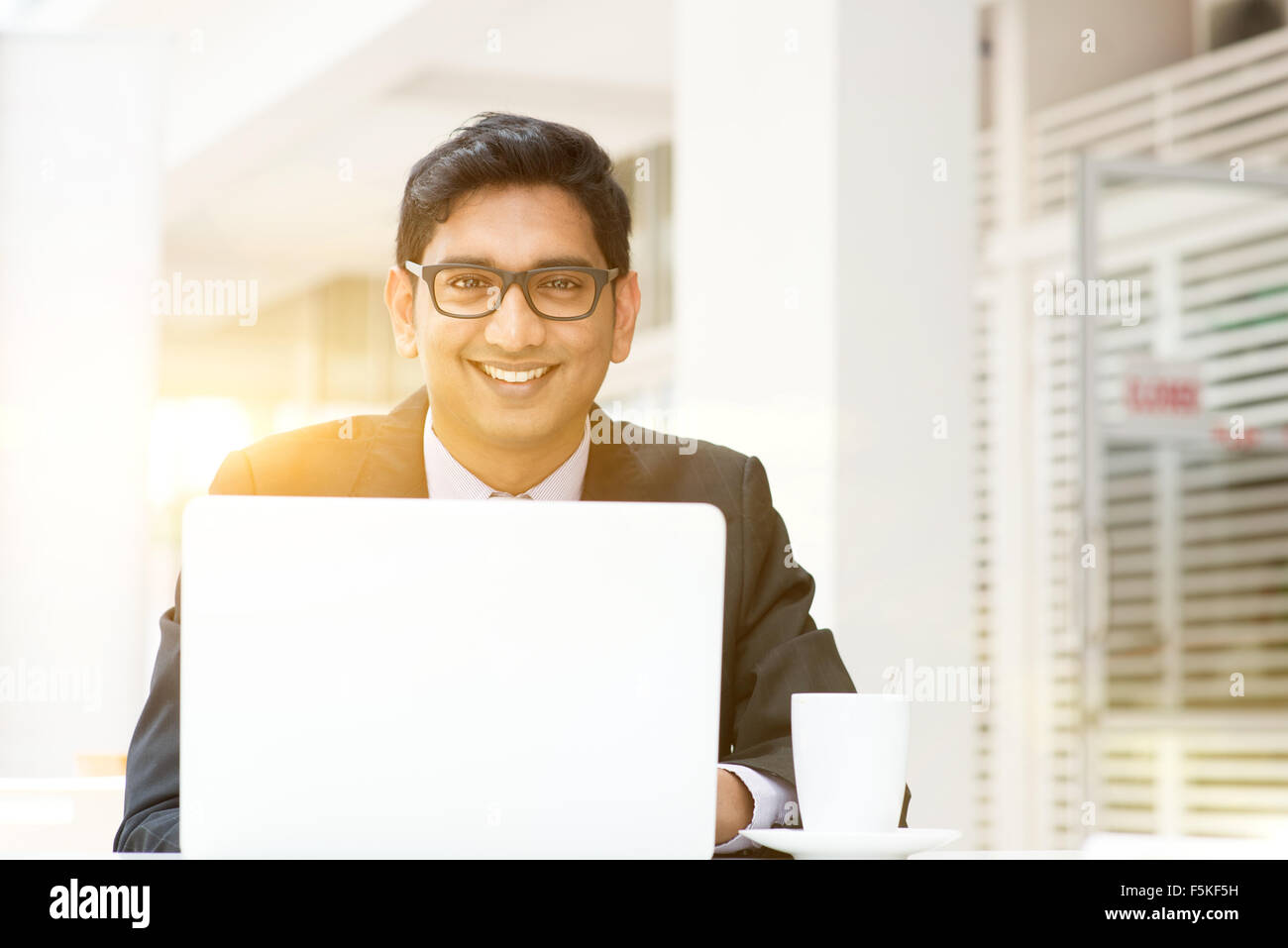 Asian Indian business people using a laptop or notebook computer at ...