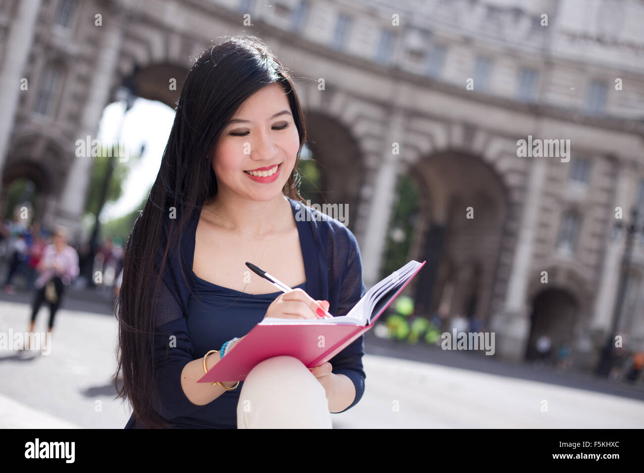 young woman writing in a book Stock Photo - Alamy