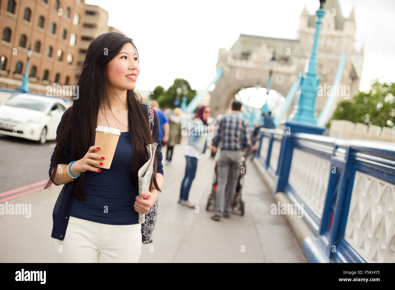 japanese woman walking over tower bridge with a coffee Stock Photo - Alamy