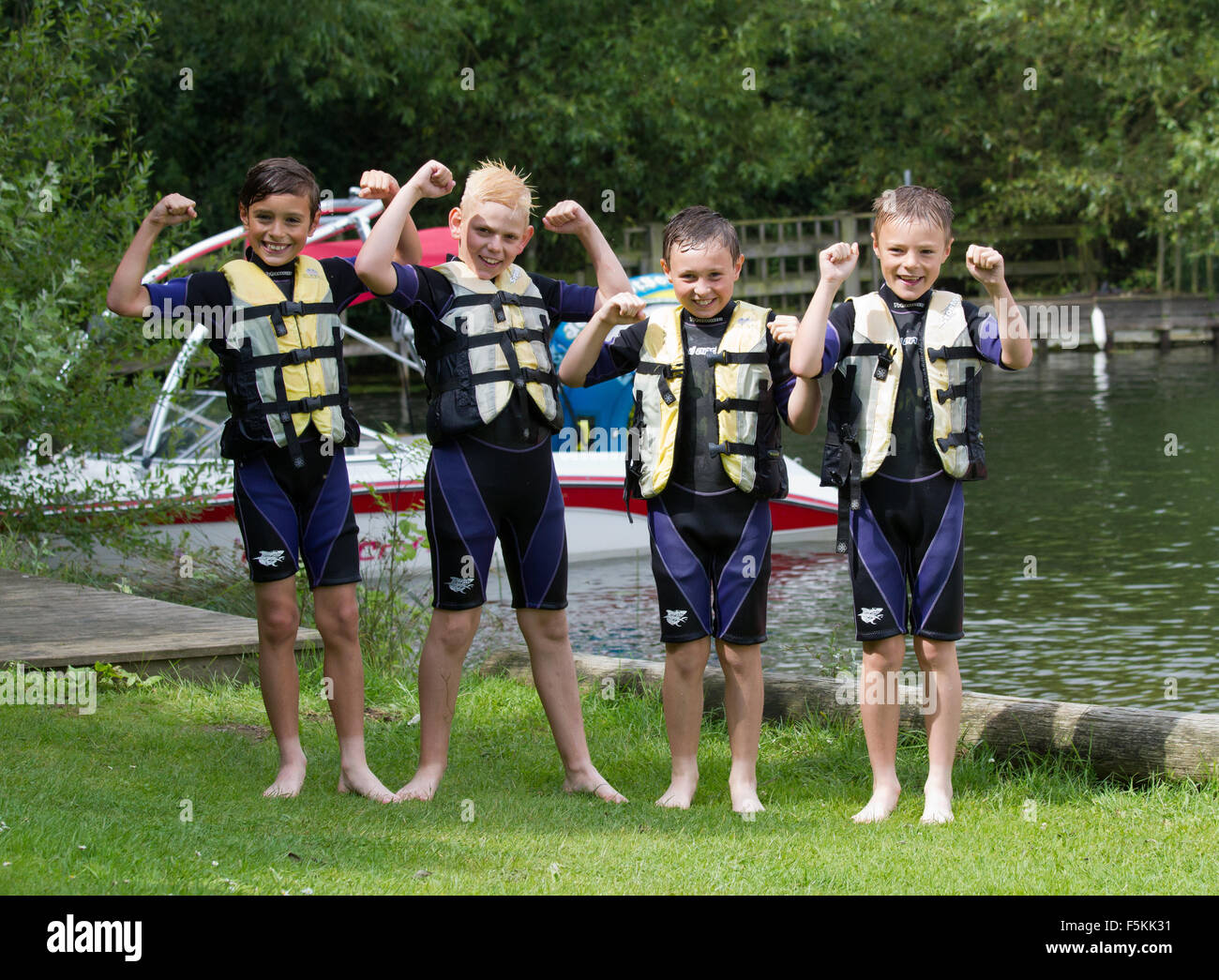 Children in life Jackets buoyancy aids wet suits Stock Photo - Alamy