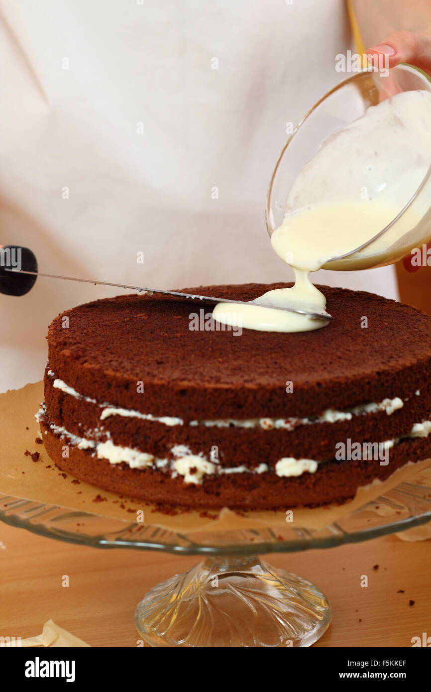 Pouring frosting on Cake. Making Chocolate Layer Cake. Series Stock ...