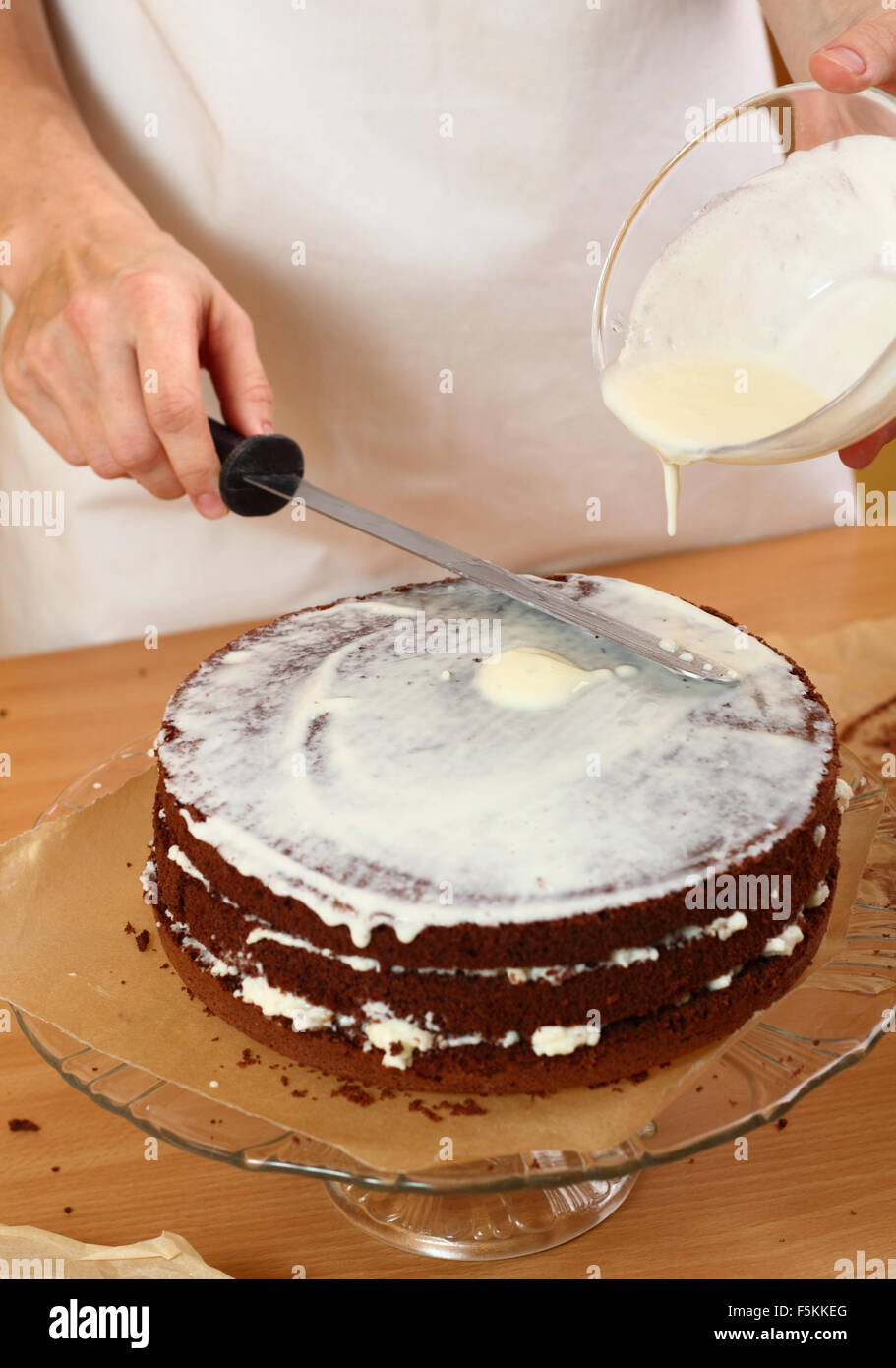 Pouring frosting on Cake. Making Chocolate Layer Cake. Series Stock ...