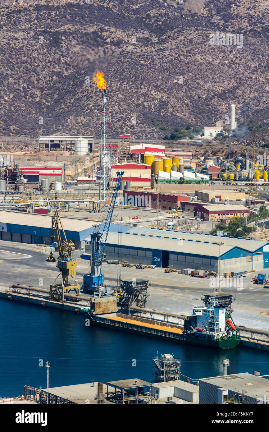 cargo ship in a port with a fireplace and a refinery fire Stock Photo ...