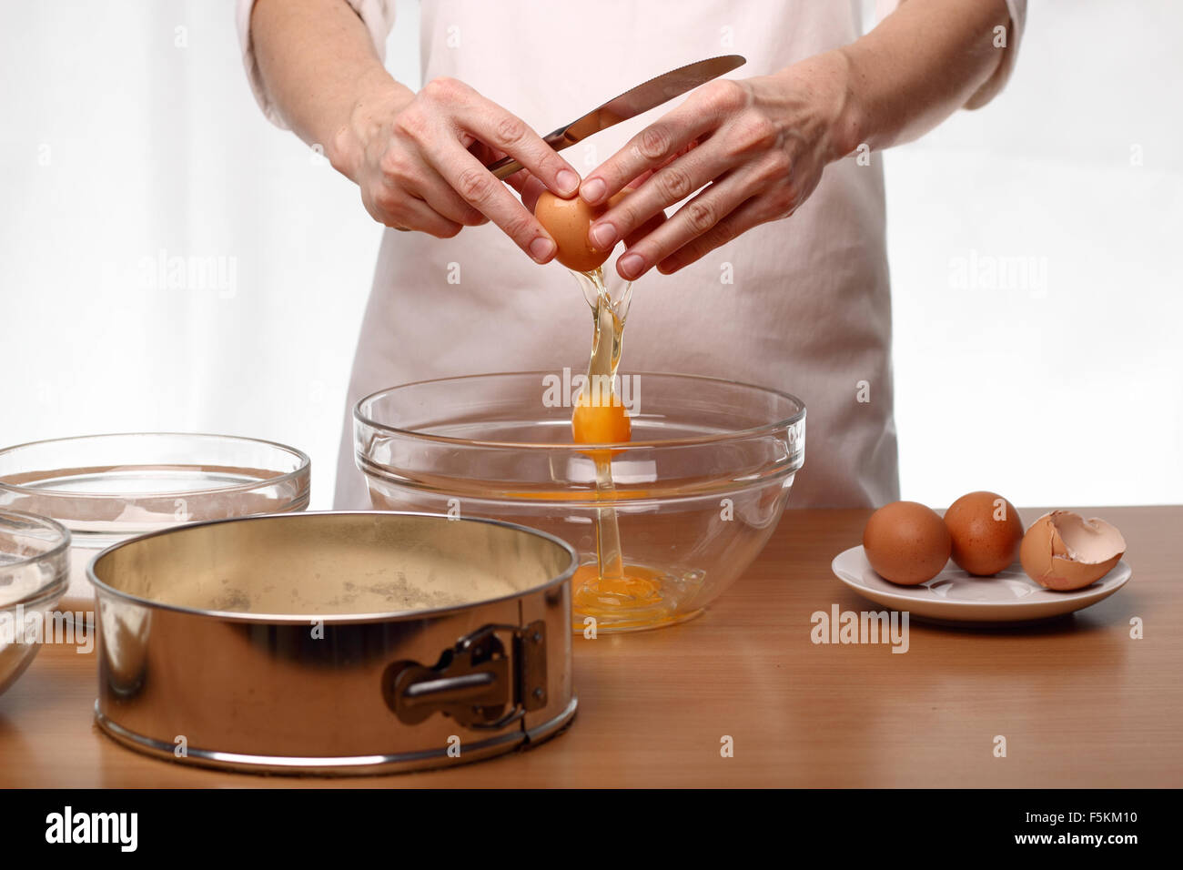 A baker cracking an egg. Making Victoria Sponge Cake. Series Stock ...