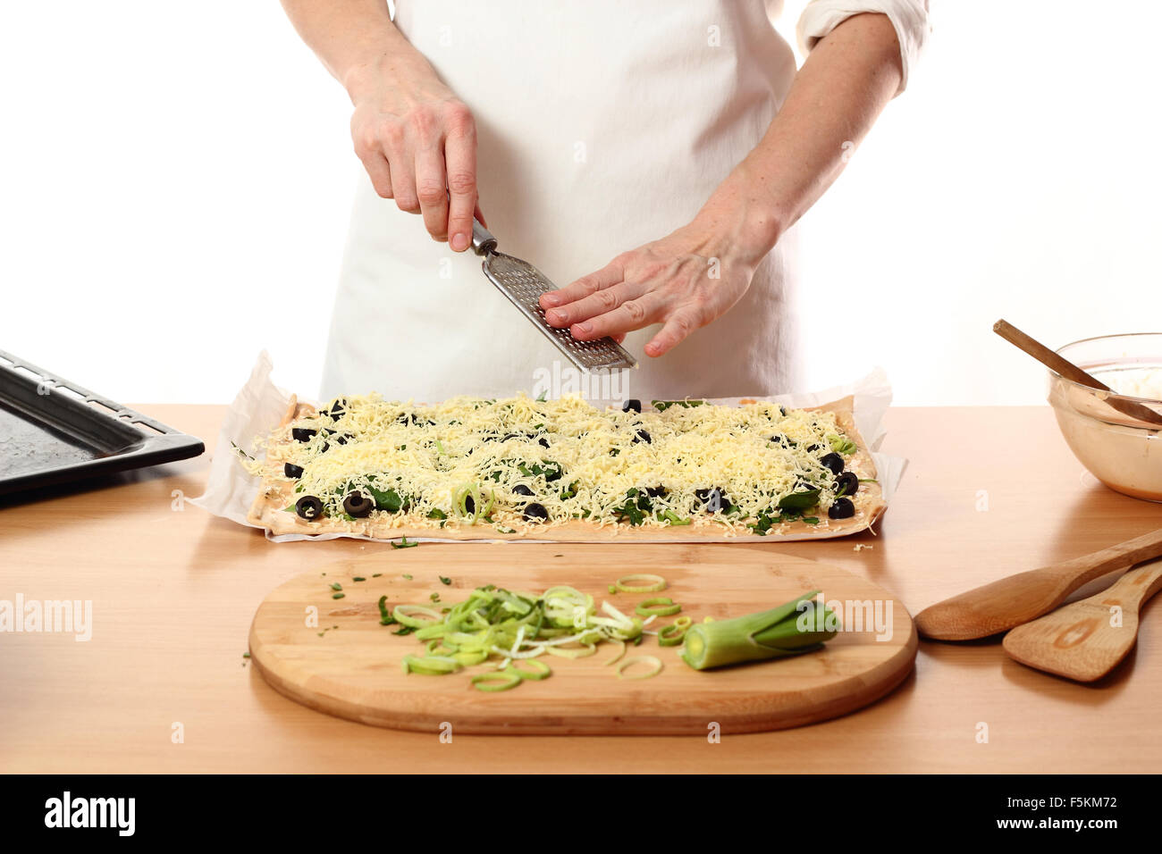 Grating cheese. Making Pizza with Leek and Spinach. Series Stock Photo ...