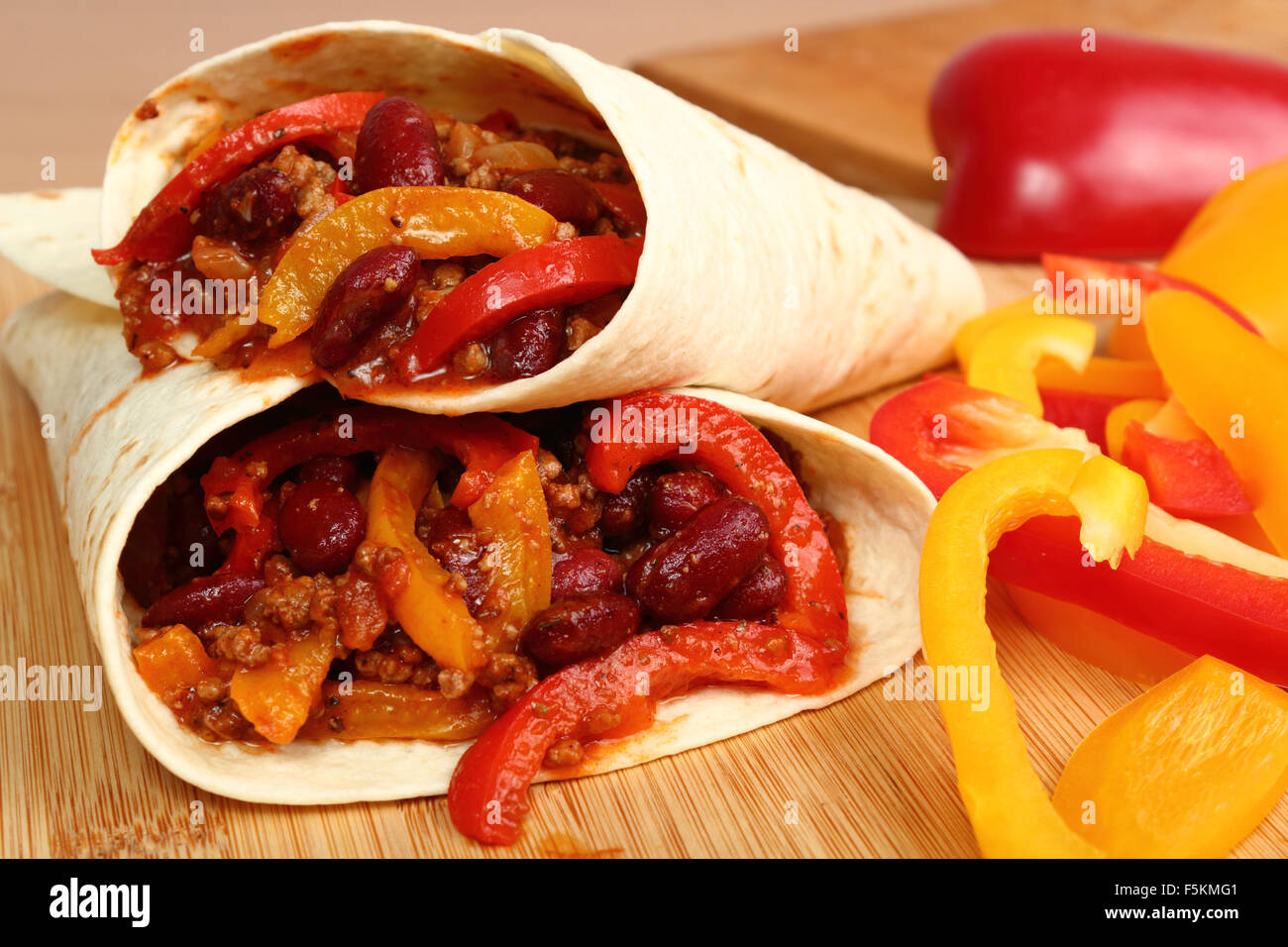 Burrito. Tortilla with meat, beans and bell pepper Stock Photo - Alamy