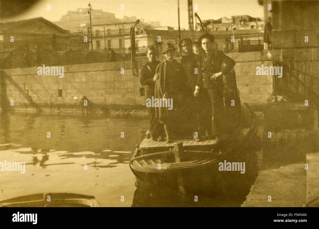 Small group of soldiers of the Italian Army on a boat in the port of ...