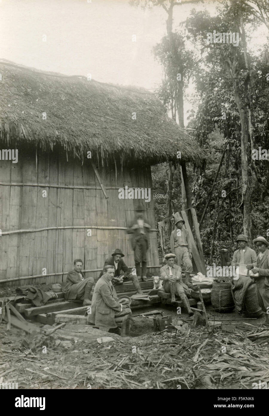 Group of workers in a forest next to a hut, Africa Stock Photo - Alamy