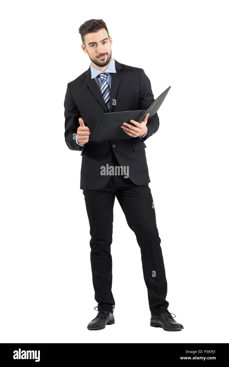 Young confident business man holding document folder with thumb up ...
