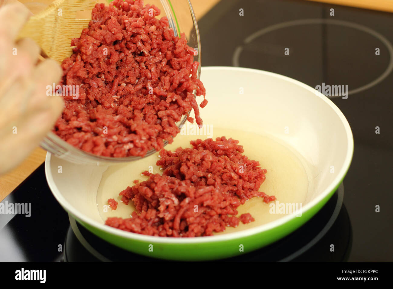 Adding ground beef into frying pan. Making enchilada tortilla with beef ...