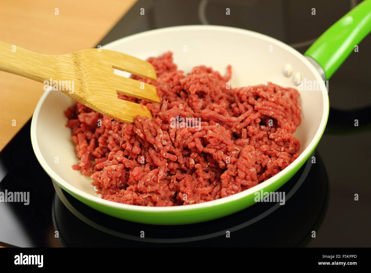 Adding ground beef into frying pan. Making enchilada tortilla with beef ...