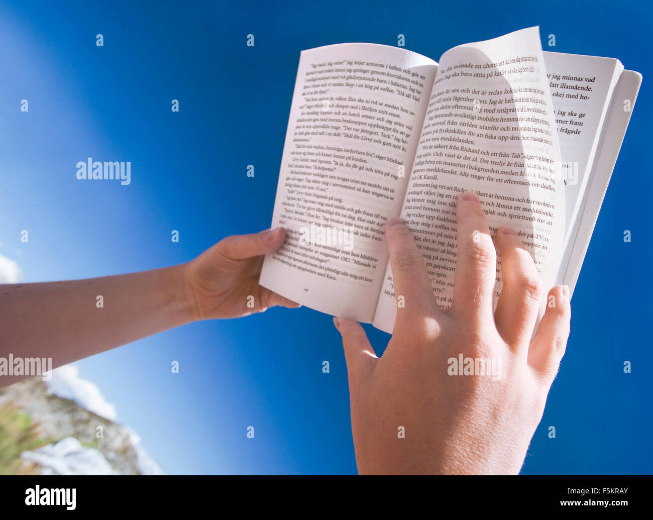 Hands holding book hi-res stock photography and images - Alamy