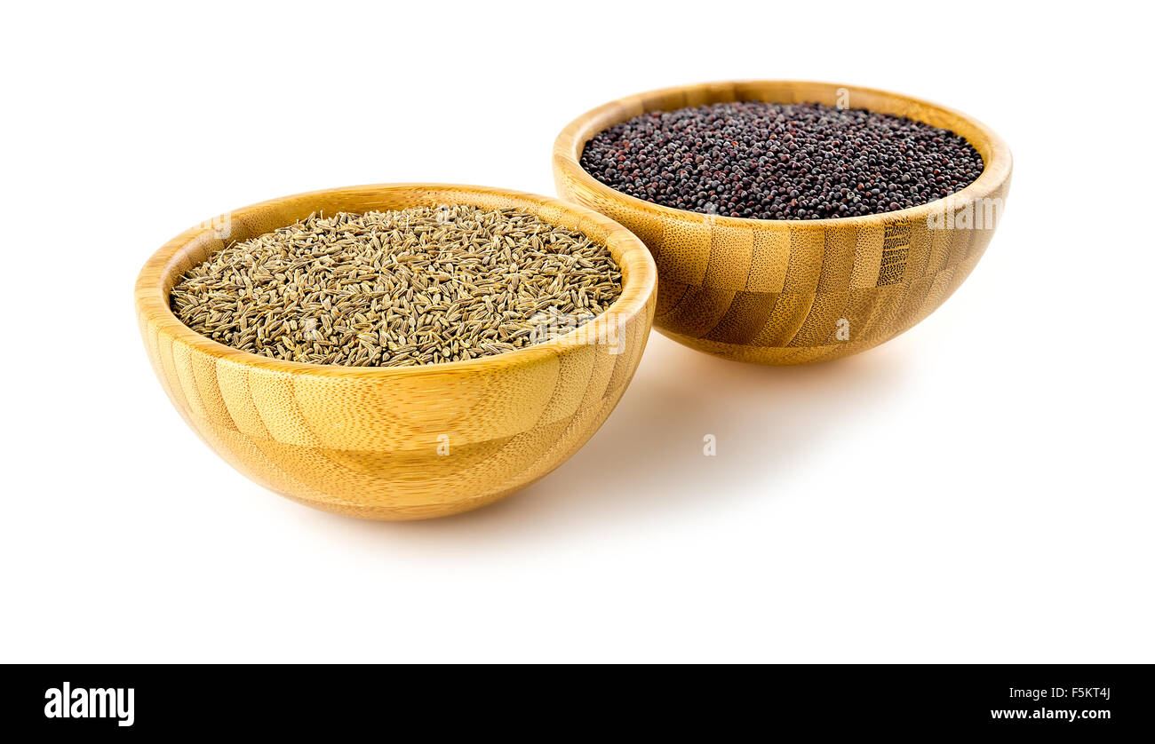 Fresh cumin seeds and spicy black mustard seeds in round wood bowls ...