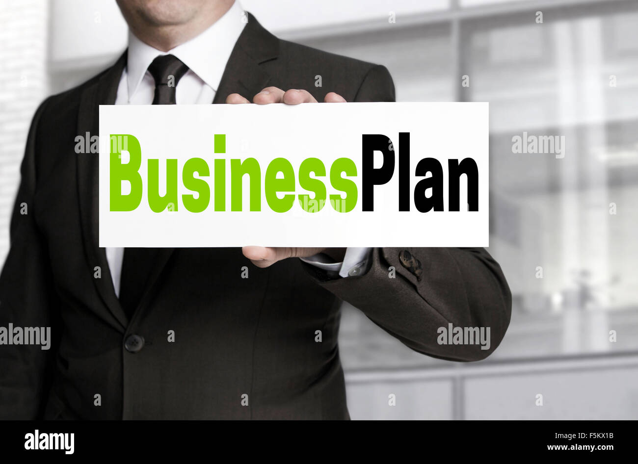 Business Plan sign is held by businessman concept Stock Photo - Alamy