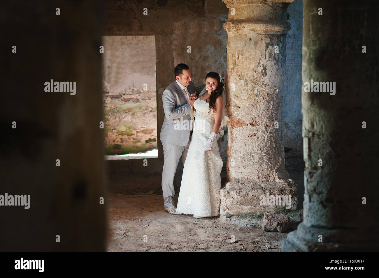 wedding couple at the dungeon with old colums Stock Photo - Alamy
