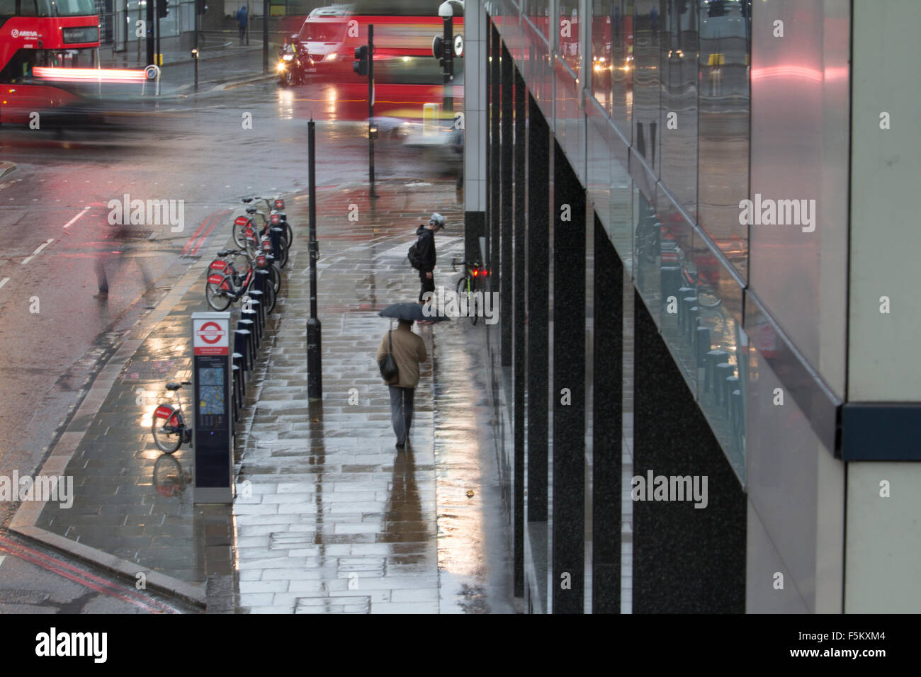 Blurred low shutter speed People with umbrellas during Rain Rainstorm ...