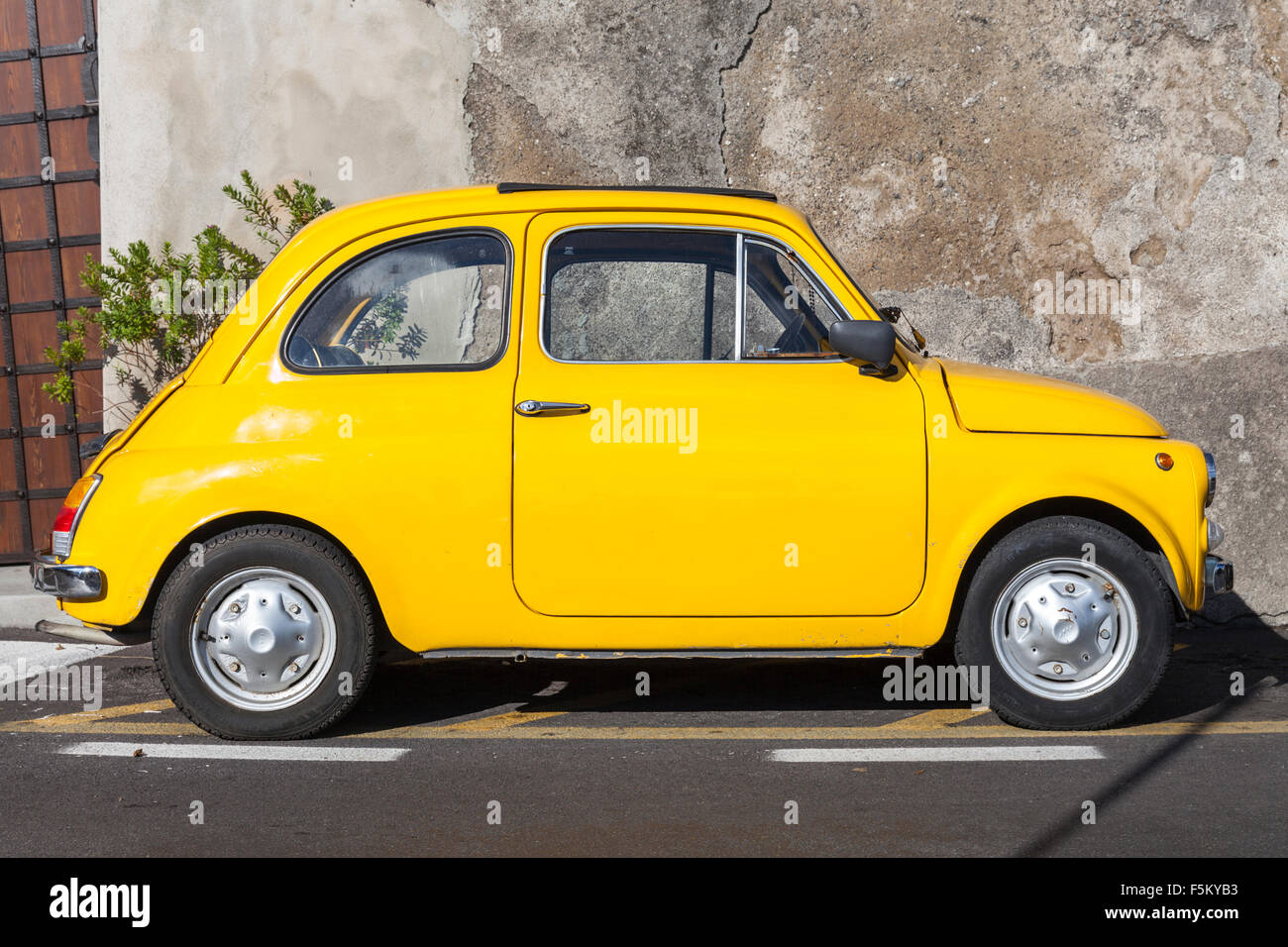 Yellow Fiat 500 Cinquecento parked in a street in Positano on the ...
