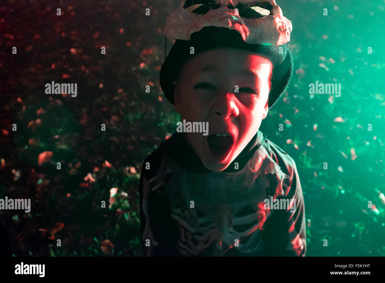 boy screaming in skeleton costume with glowing red side lighting at ...