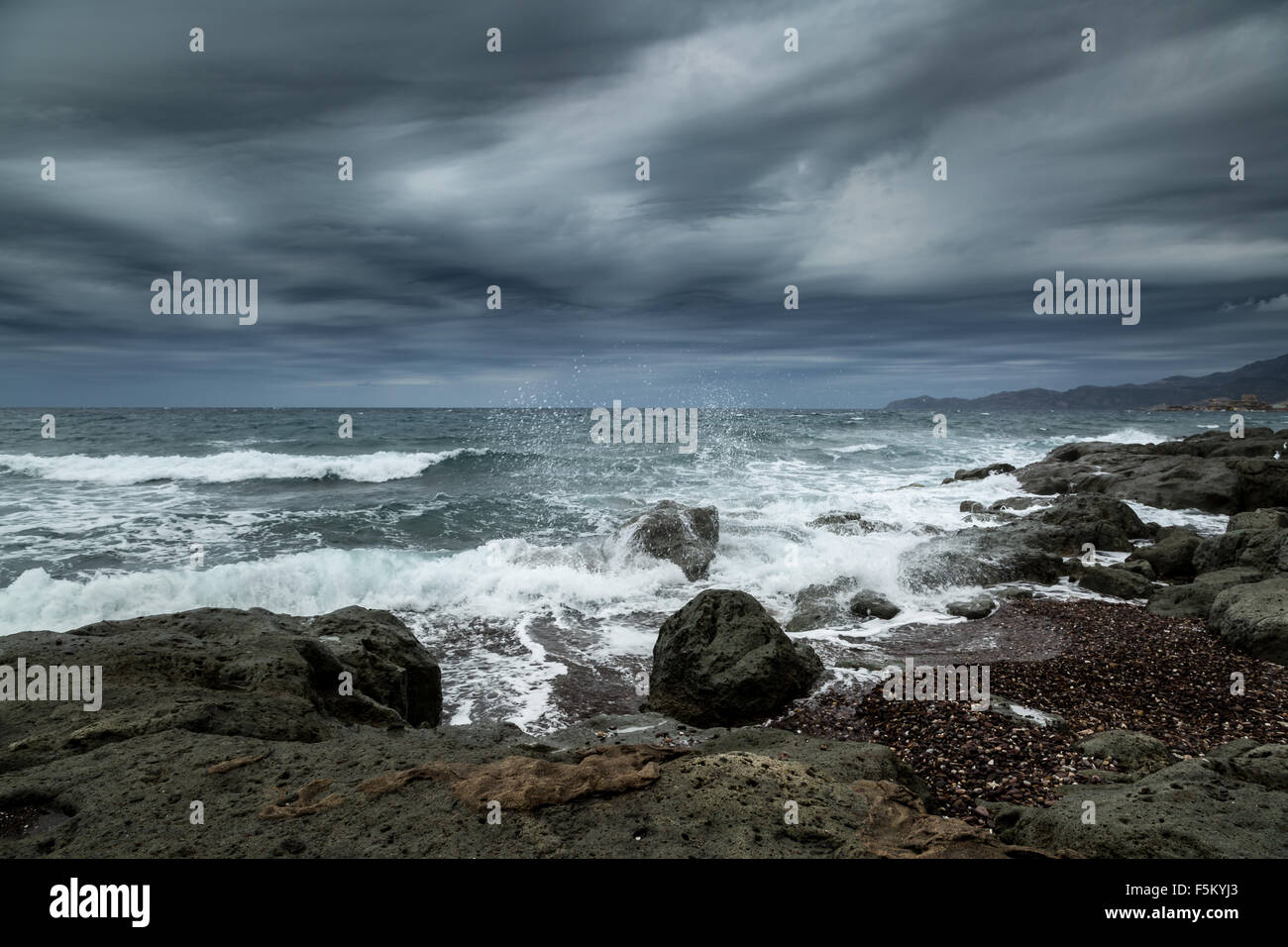 Rough seas crashing into rocks near Bosa on the west coast of Sardinia ...