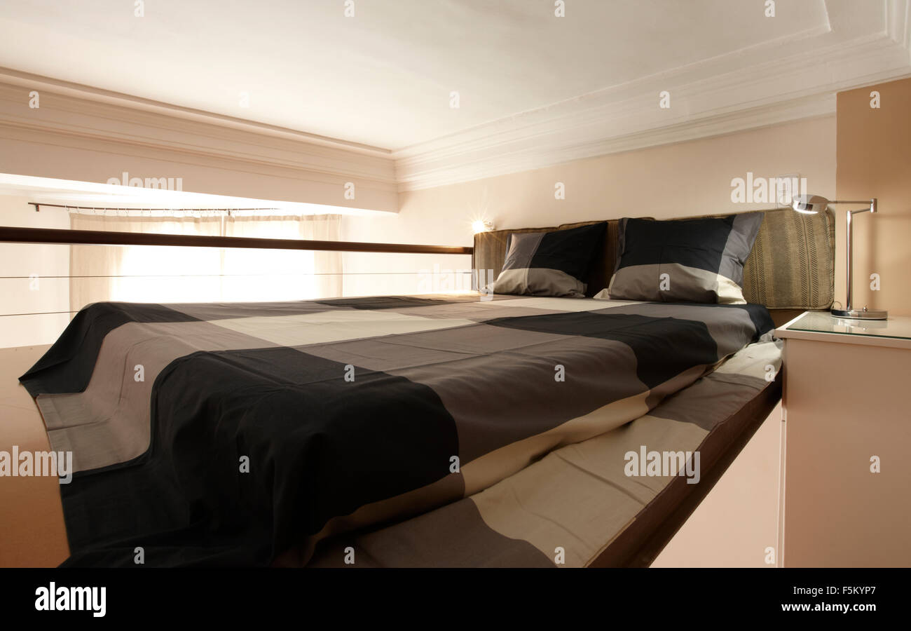 A modern bedroom in an overhead attic Stock Photo - Alamy