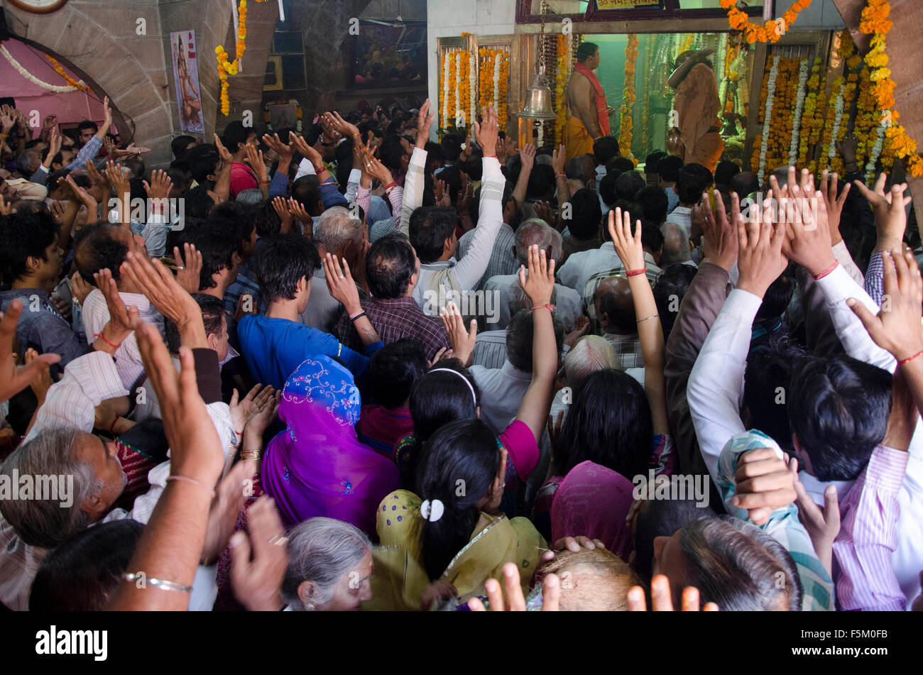 People raising hands in aarti temple, jodhpur, rajasthan, india, asia ...