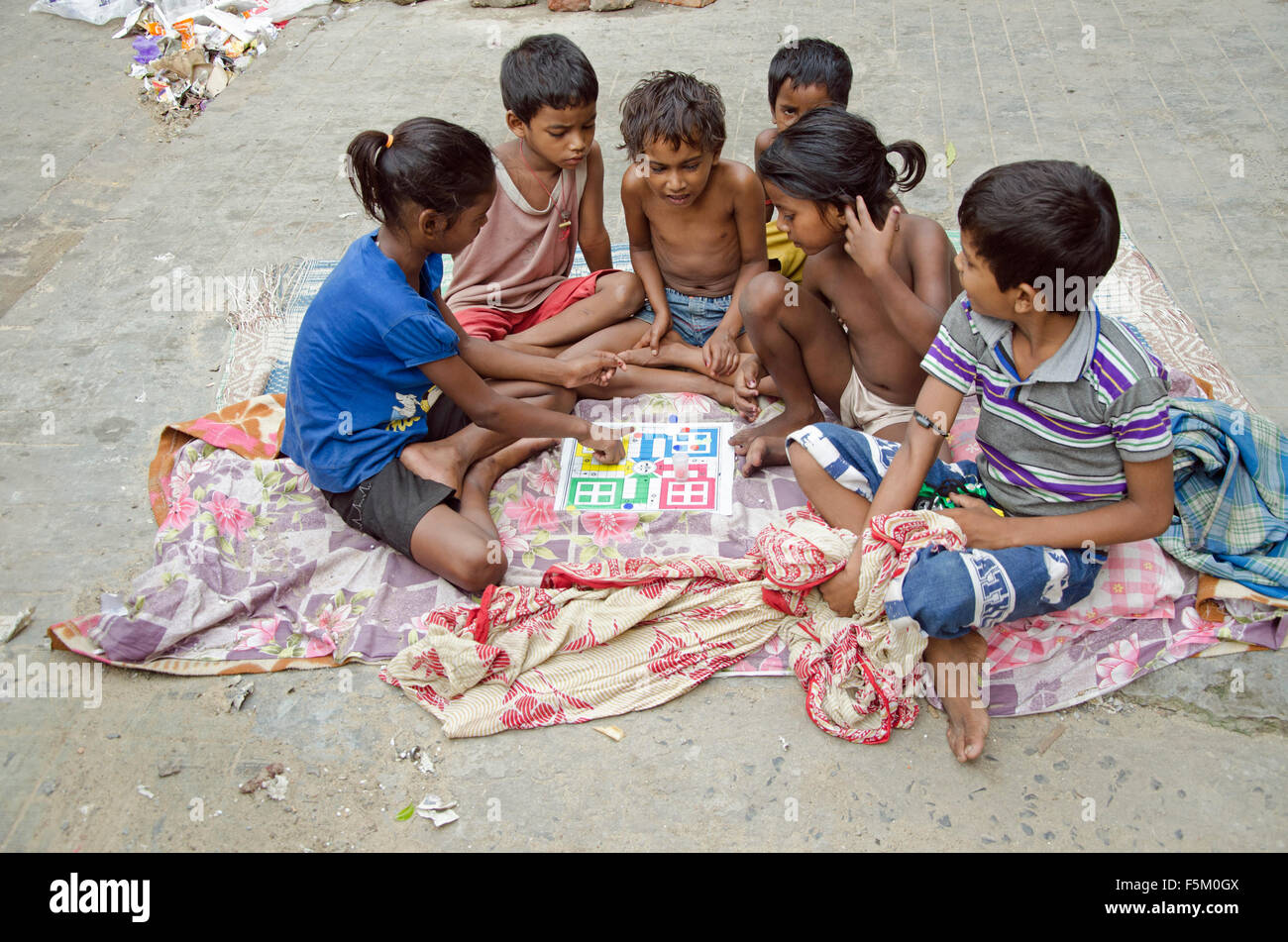Children playing ludo game on footpath, kolkata, west bengal, india ...