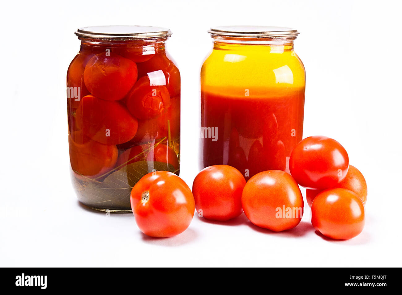 Fresh and canned red tomatoes in glass jar isolated on white background ...