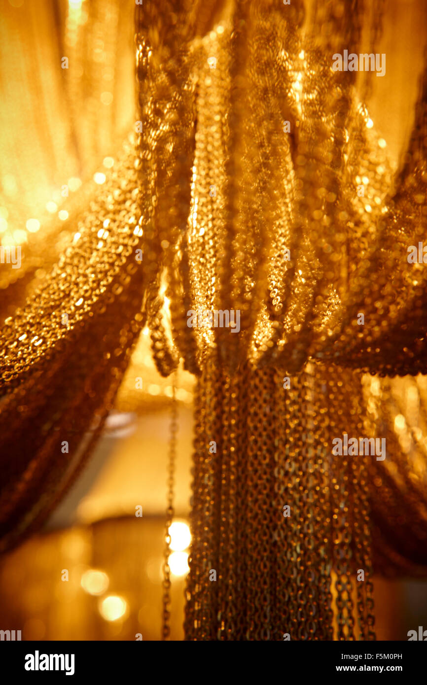Long and wide chain curtains gold tone vertical Stock Photo - Alamy