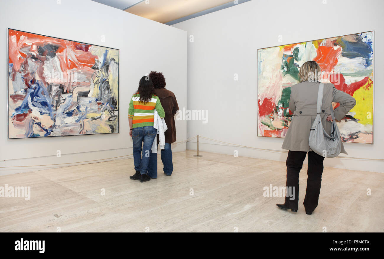 people inside a museum in front of a picture looking at it Stock Photo ...