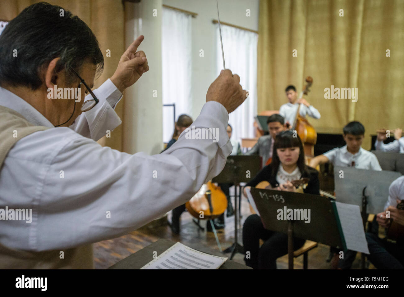 Kyrgyz authentic musical instruments orchestra play with conductor ...