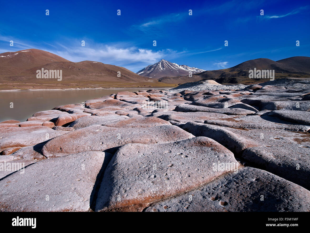 Piedras Rojas (Red Rocks) with dormant volcano in distance. San Pedro ...