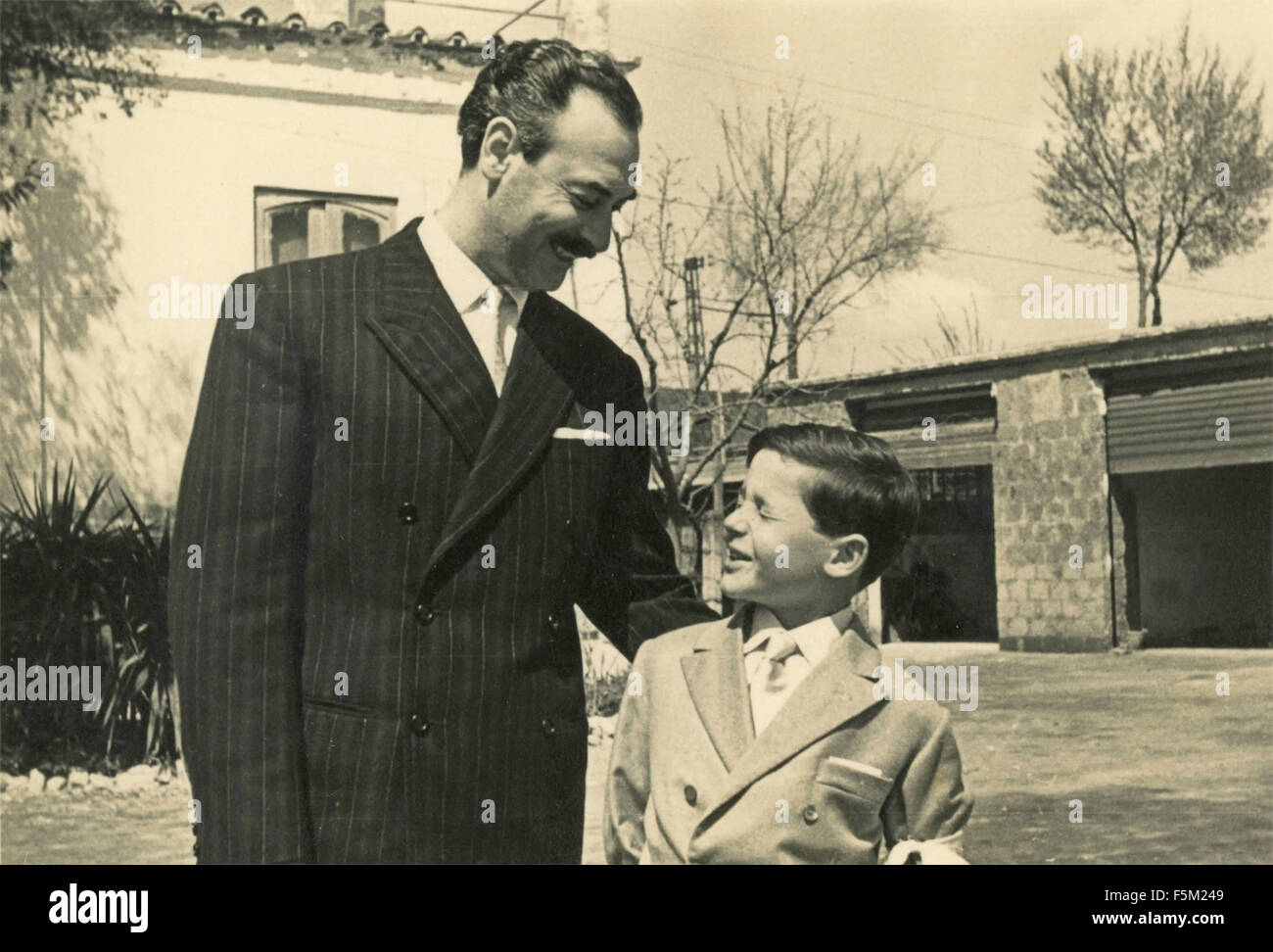 Elegant father and son smiling, Italy Stock Photo - Alamy