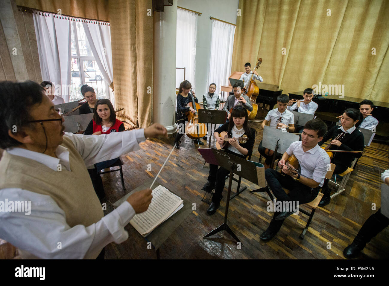 Kyrgyz authentic musical instruments orchestra play with conductor ...