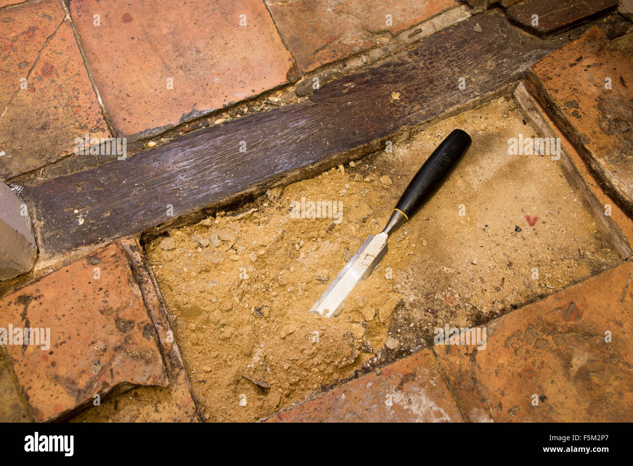 Clay floor tiles being lifted Stock Photo - Alamy