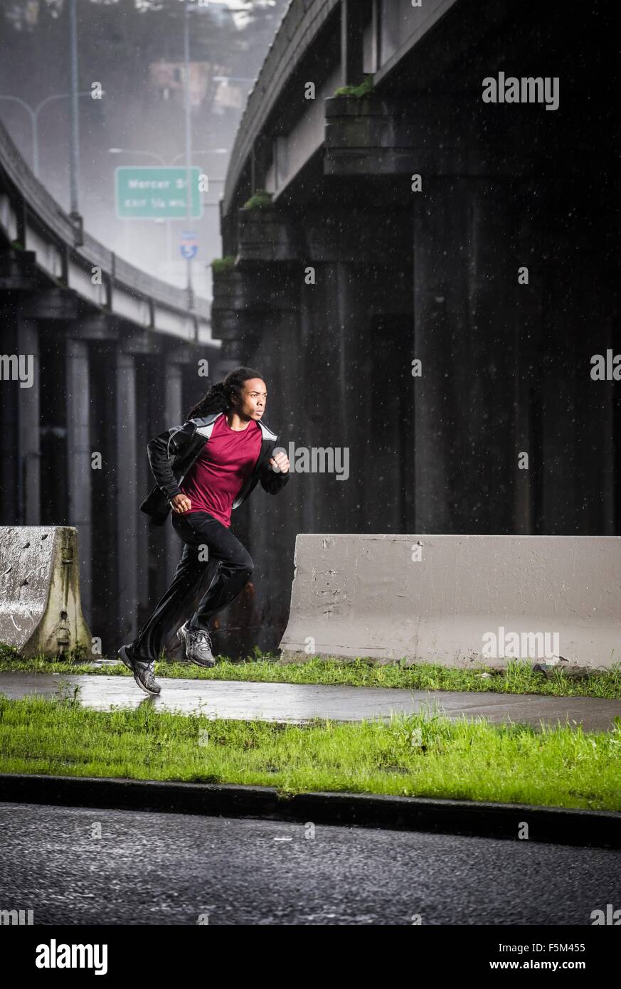 Male boxer running below urban flyover Stock Photo - Alamy