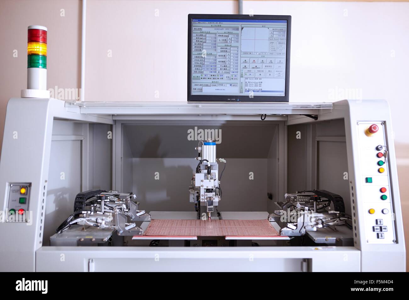 Cutting machine in manufacturing plant cutting flexible circuits Stock ...